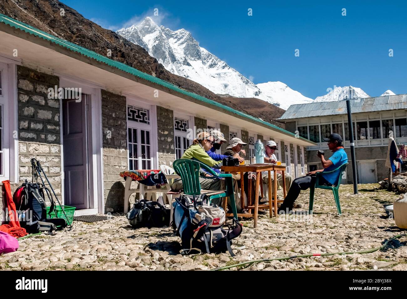 Nepal. Island Peak Trek. European trekkers relaxing on the terrace of ...