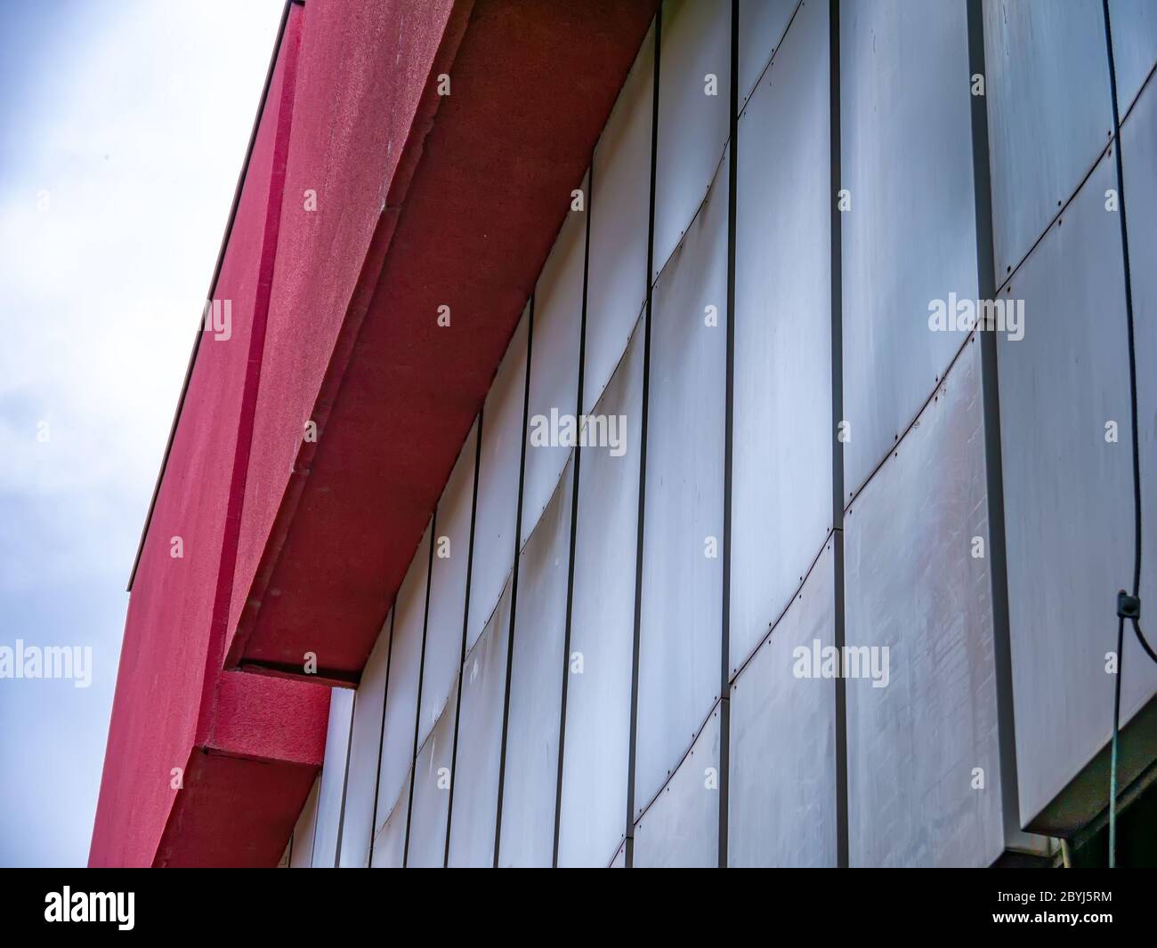 Grey and red walls of a modern building in Gyor, Hungary Stock Photo ...