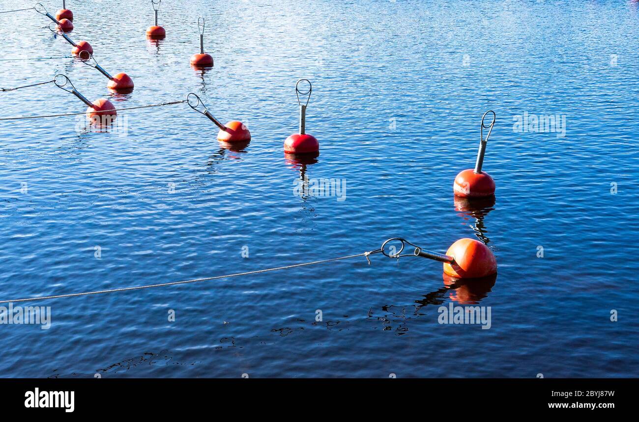 Red buoys on the sea waves background Stock Photo - Alamy
