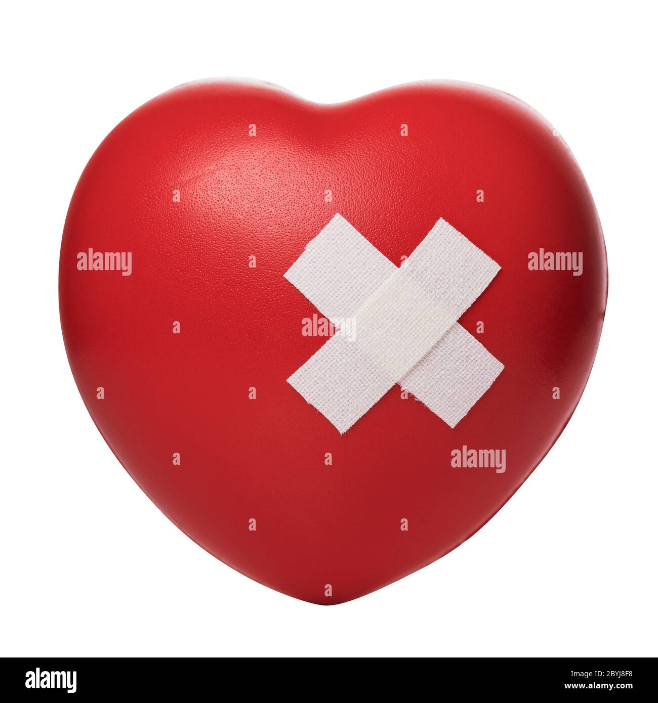 Red heart taped with a medical plaster isolated on a white background ...