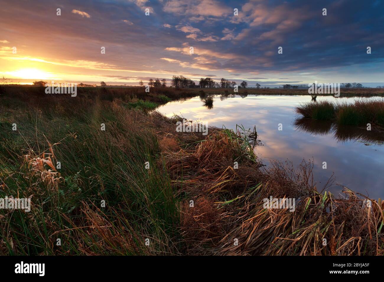 sunrise over wild river Stock Photo - Alamy