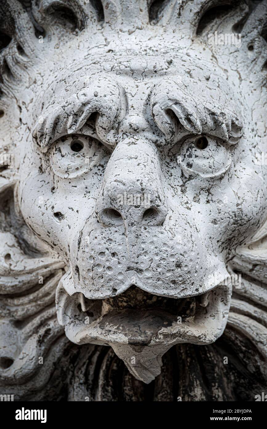 Funny ancient decoration element of a scary lion head at roof of ...