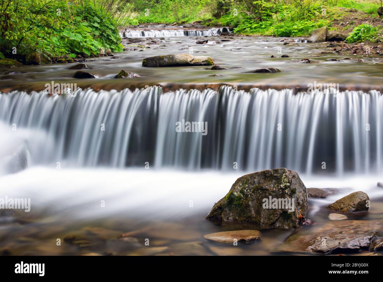 Small stream waterfall on spring forest. Nature background. Landscape ...