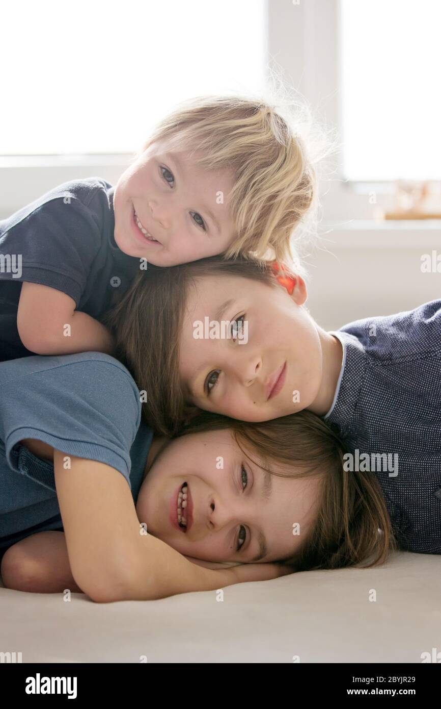 Three friends hugging indoors hi-res stock photography and images - Alamy