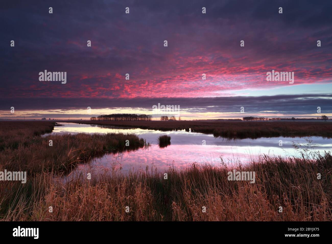 dramatic purple sunrise over river Stock Photo - Alamy