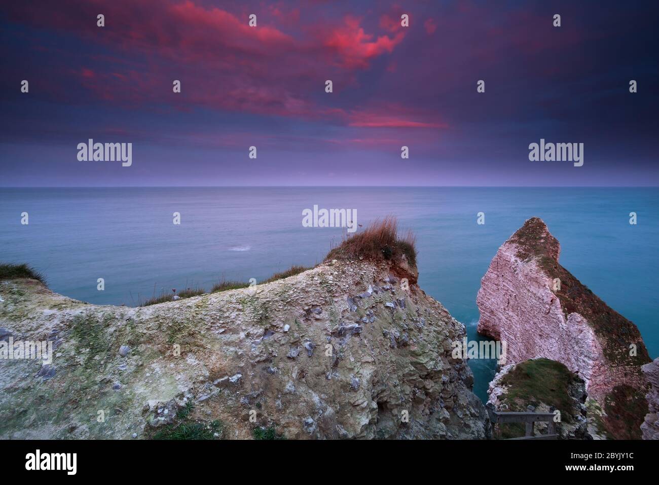 dramatic red sunrise over cliffs in ocean Stock Photo - Alamy