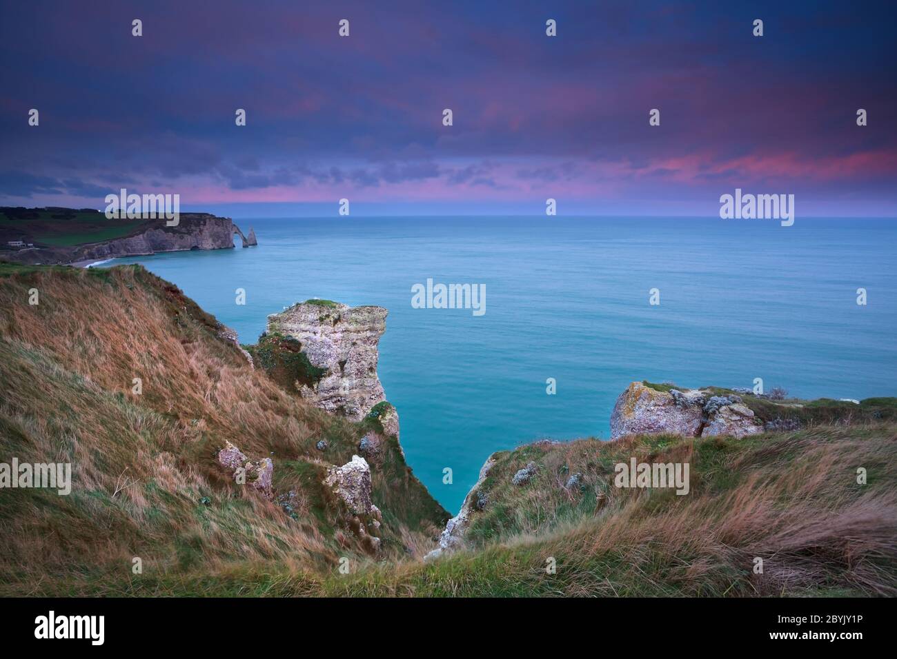 sunrise over cliffs in ocean Stock Photo - Alamy