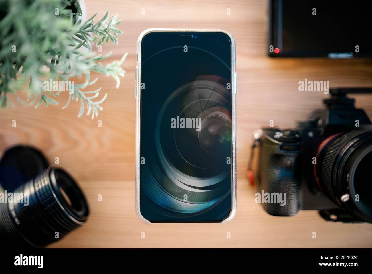 Technology. Top view of smartphone, dslr camera and lens on wooden ...