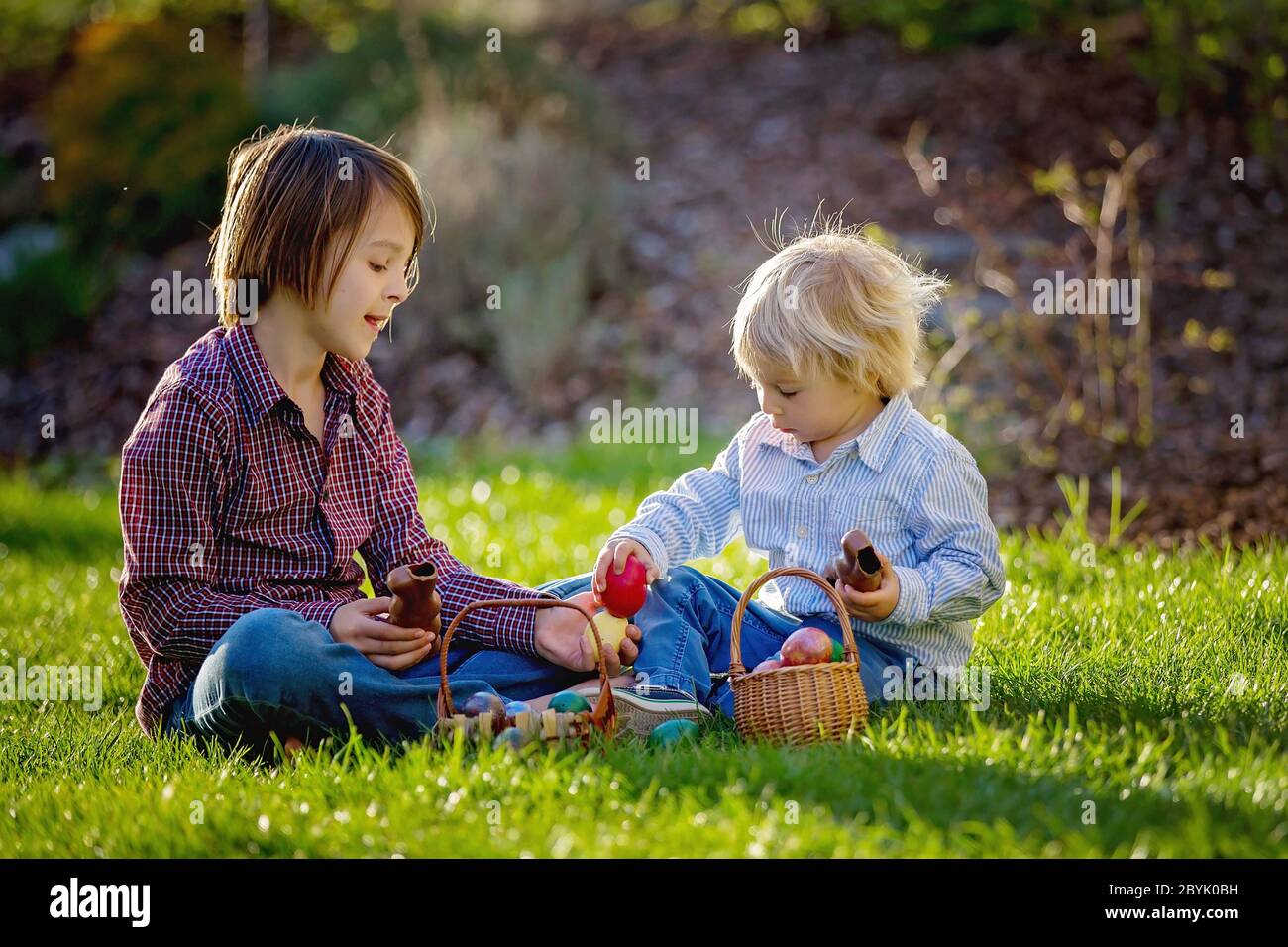 Cute children, eating chocolate bunnies and fighting with easter eggs ...