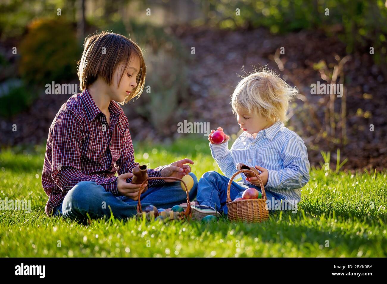 Cute children, eating chocolate bunnies and fighting with easter eggs ...