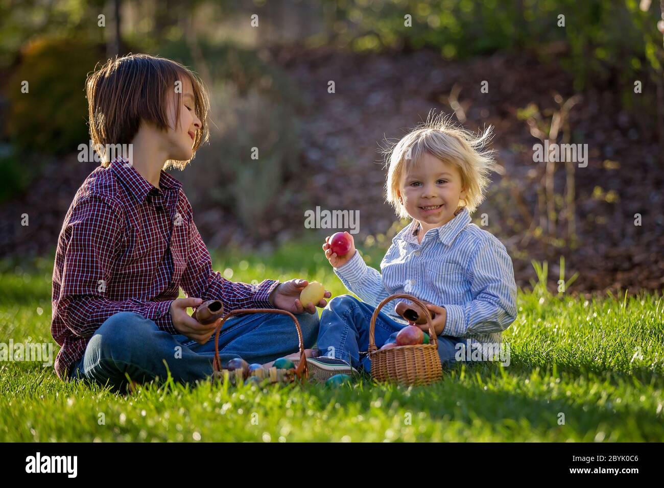 Cute children, eating chocolate bunnies and fighting with easter eggs ...
