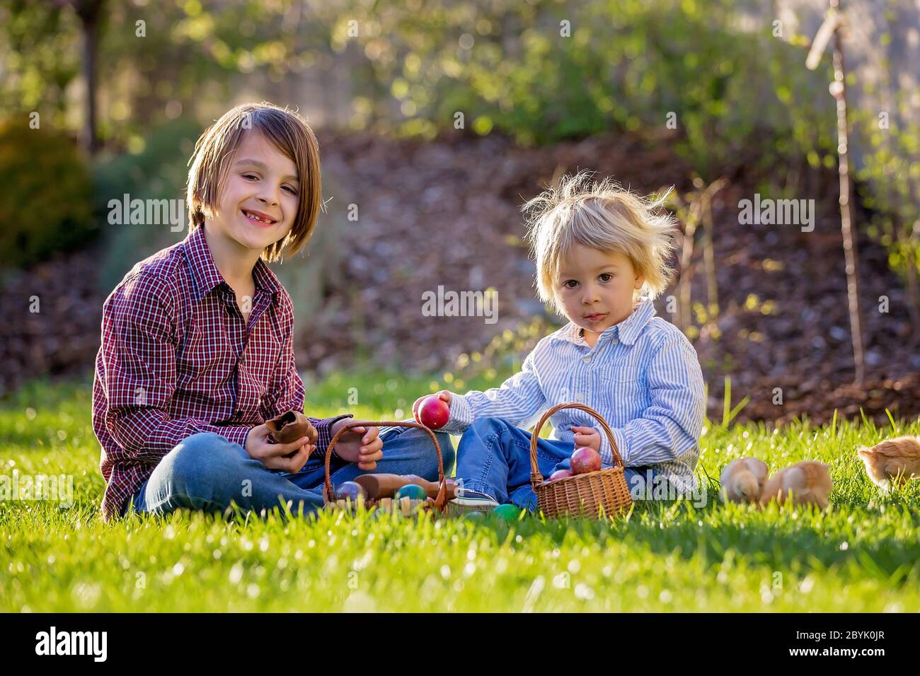 Cute children, eating chocolate bunnies and fighting with easter eggs ...