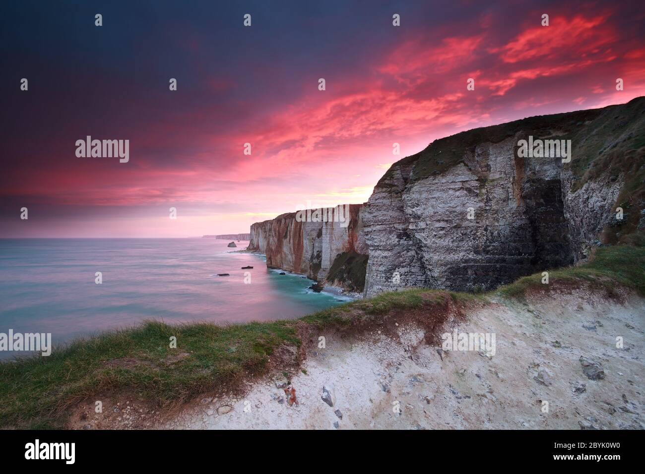 dramatic fire sunrise over cliffs in ocean Stock Photo - Alamy