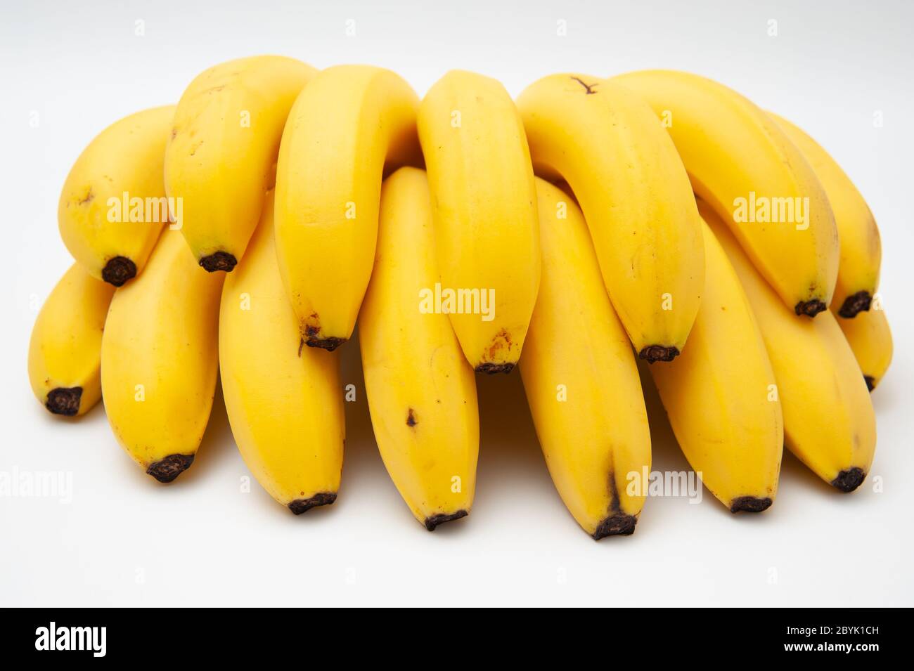 Banana cluster isolated on white background. Front view Stock Photo - Alamy