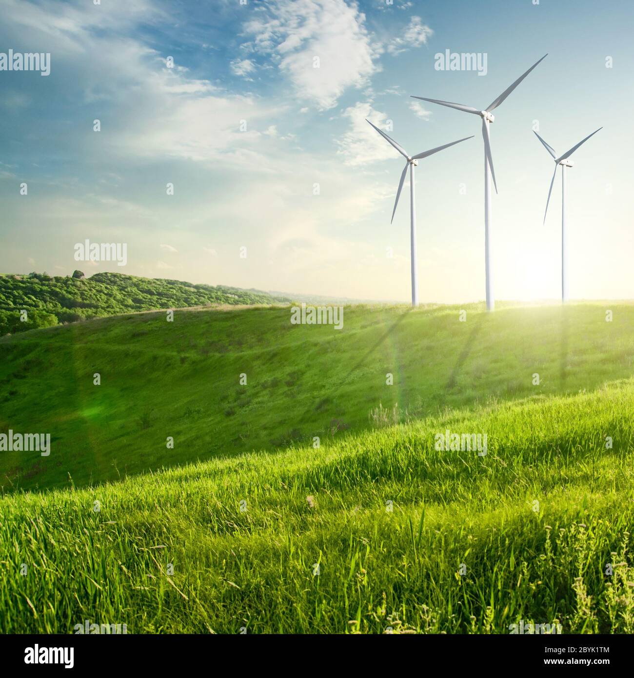 Wind generators turbines on sunset summer landscape Stock Photo - Alamy