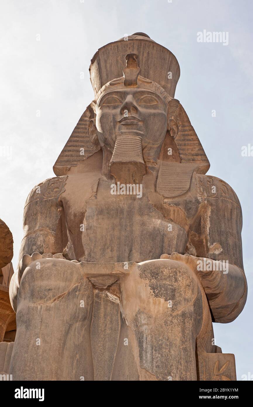 Large statue and hieroglypic carvings of Ramses II at the ancient ...