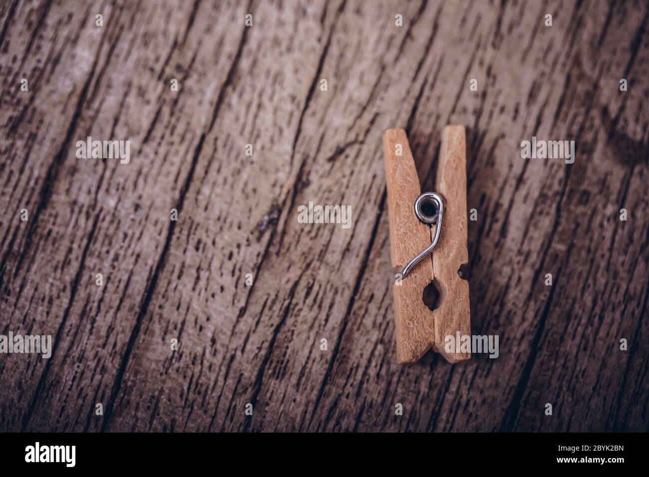 Wooden clothespin on vintage rustic background. The beauty of simple ...
