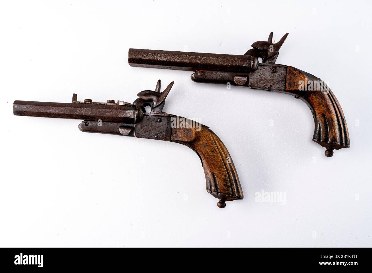 two old duel pistols from metal rusty in studio Stock Photo - Alamy