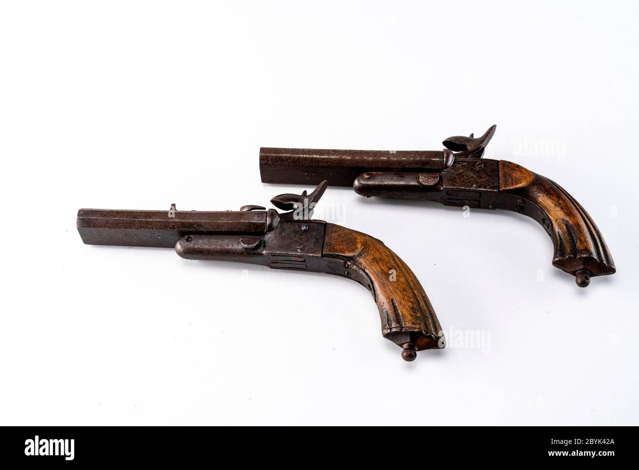 two old duel pistols from metal rusty in studio Stock Photo - Alamy
