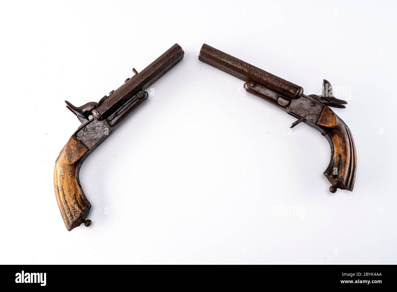 two old duel pistols from metal rusty in studio Stock Photo - Alamy