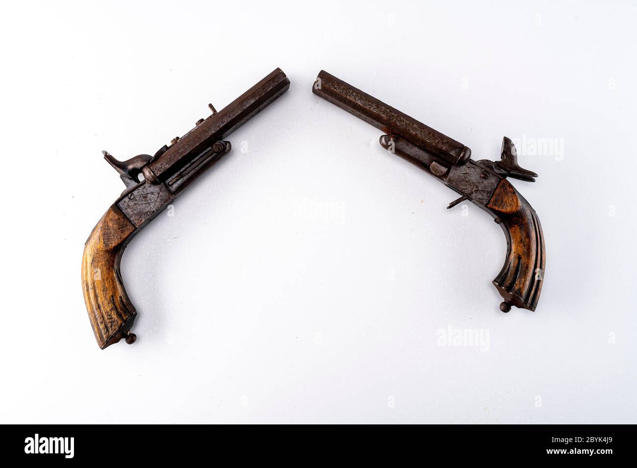 two old duel pistols from metal rusty in studio Stock Photo - Alamy