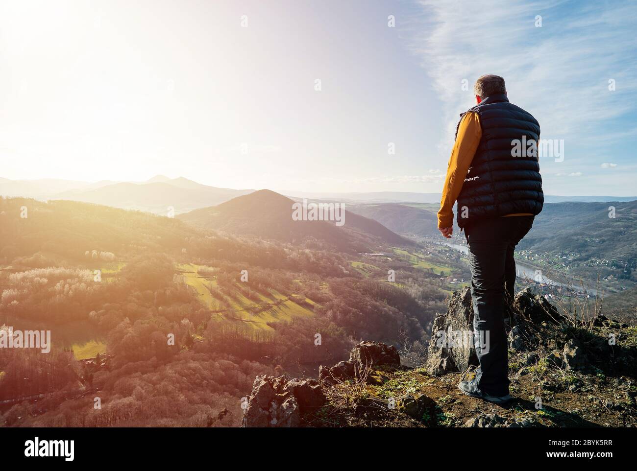 Happy old man just reaches the top of hill. Handsome senior to the ...