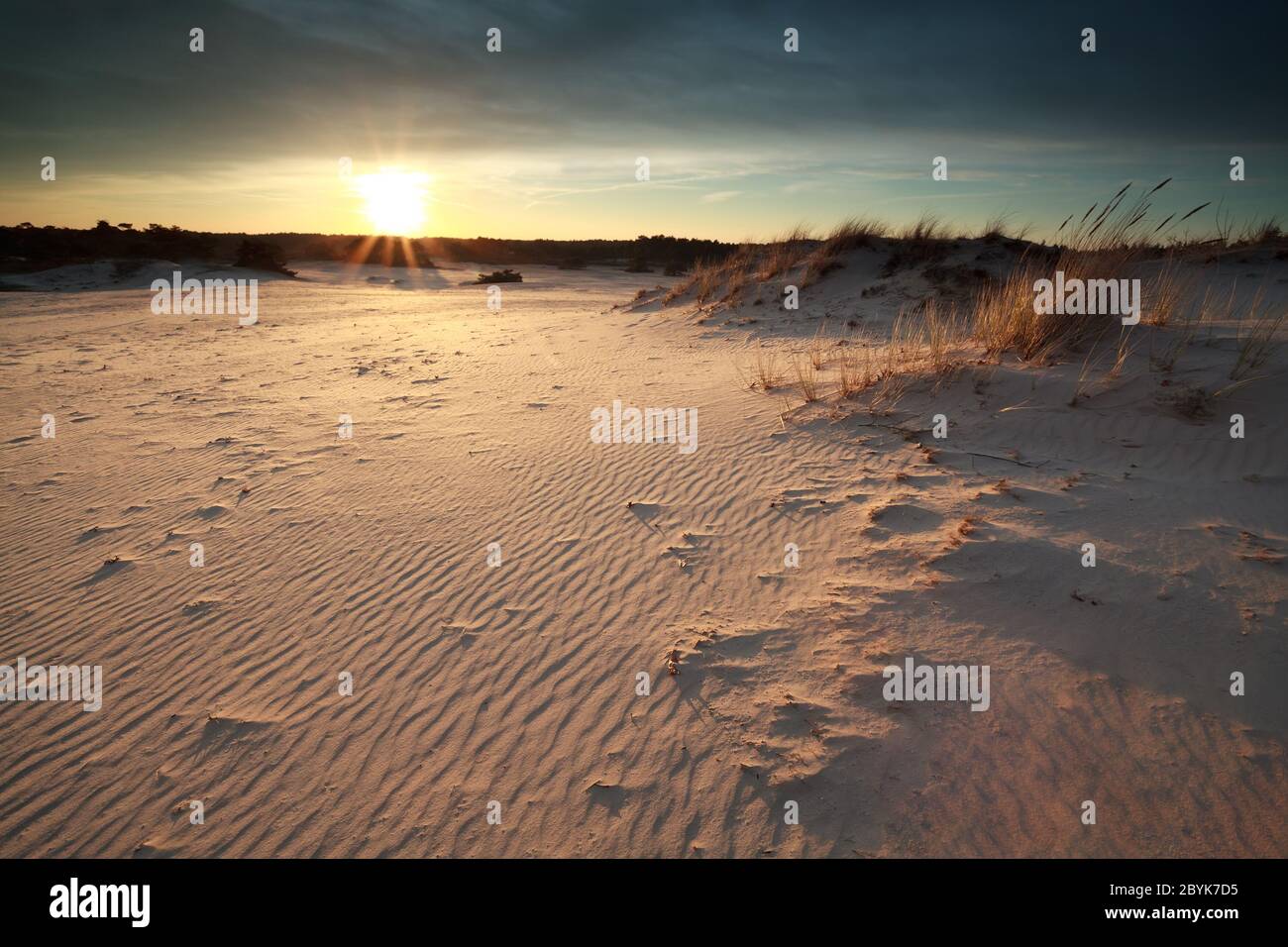 sunset over sand dunes Stock Photo - Alamy