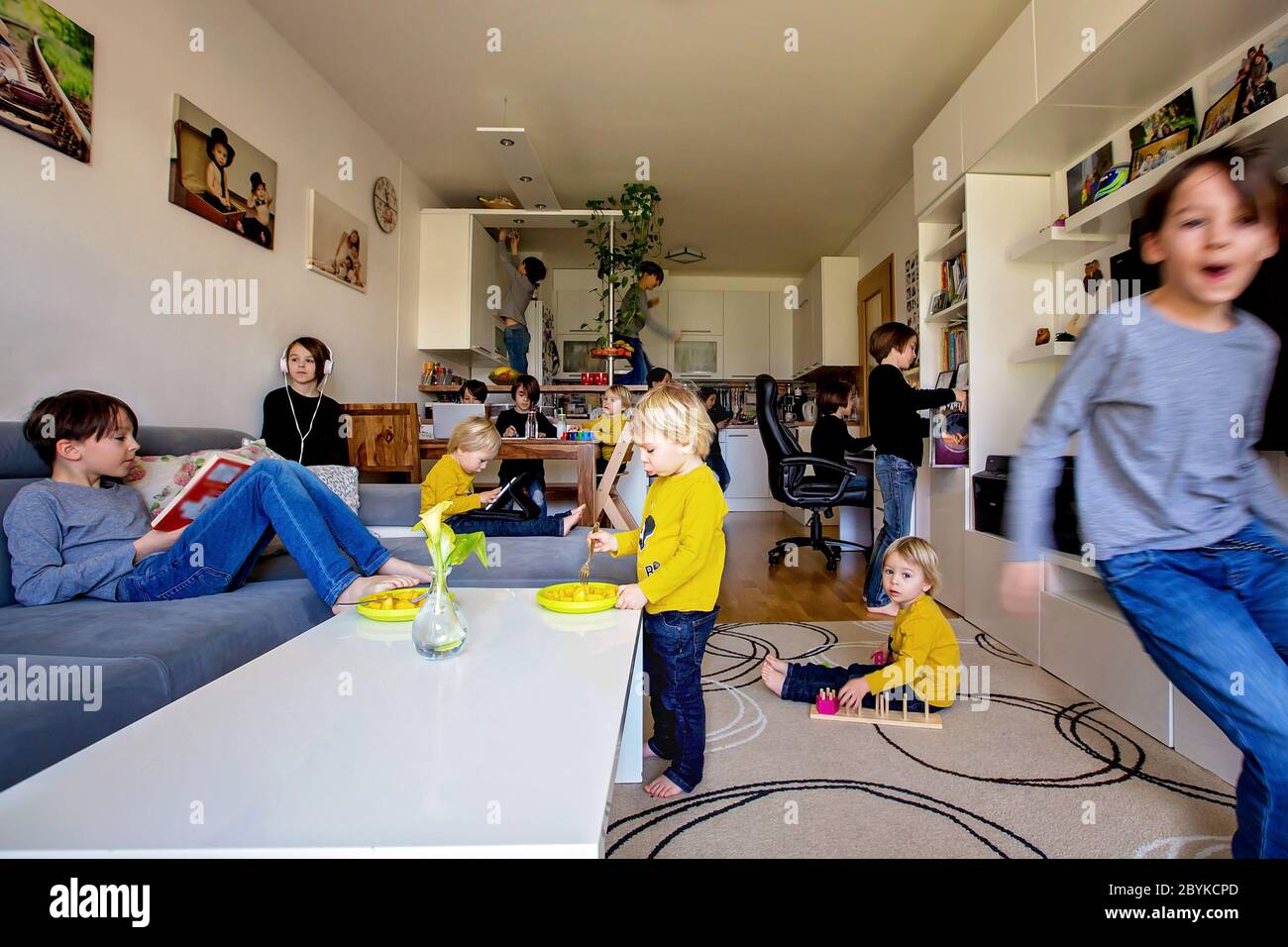 Many kids, doing different activities at home, reading book, playing ...