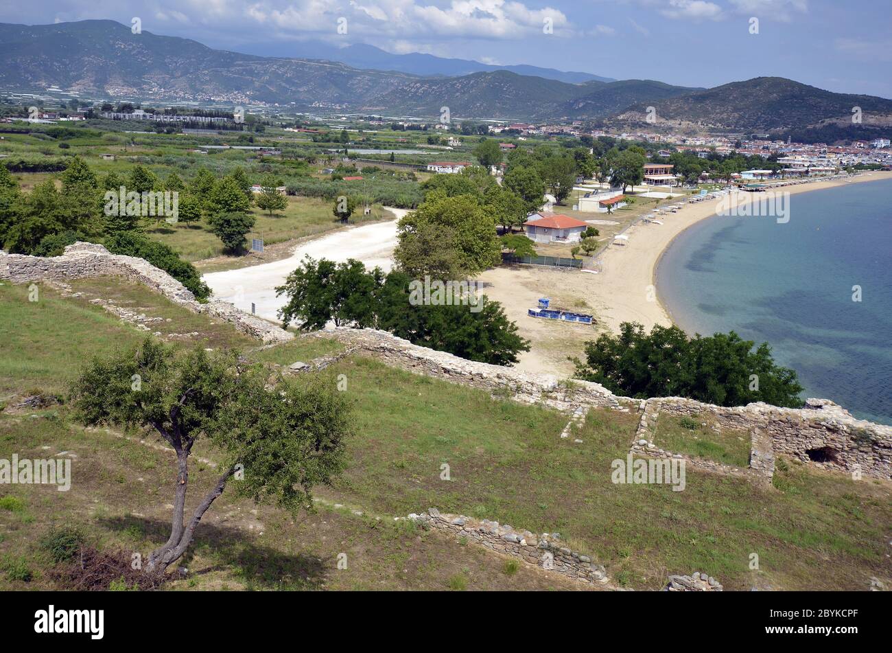 Greece, beach of Nea Peramos and ruins of fortified wall from medieval ...