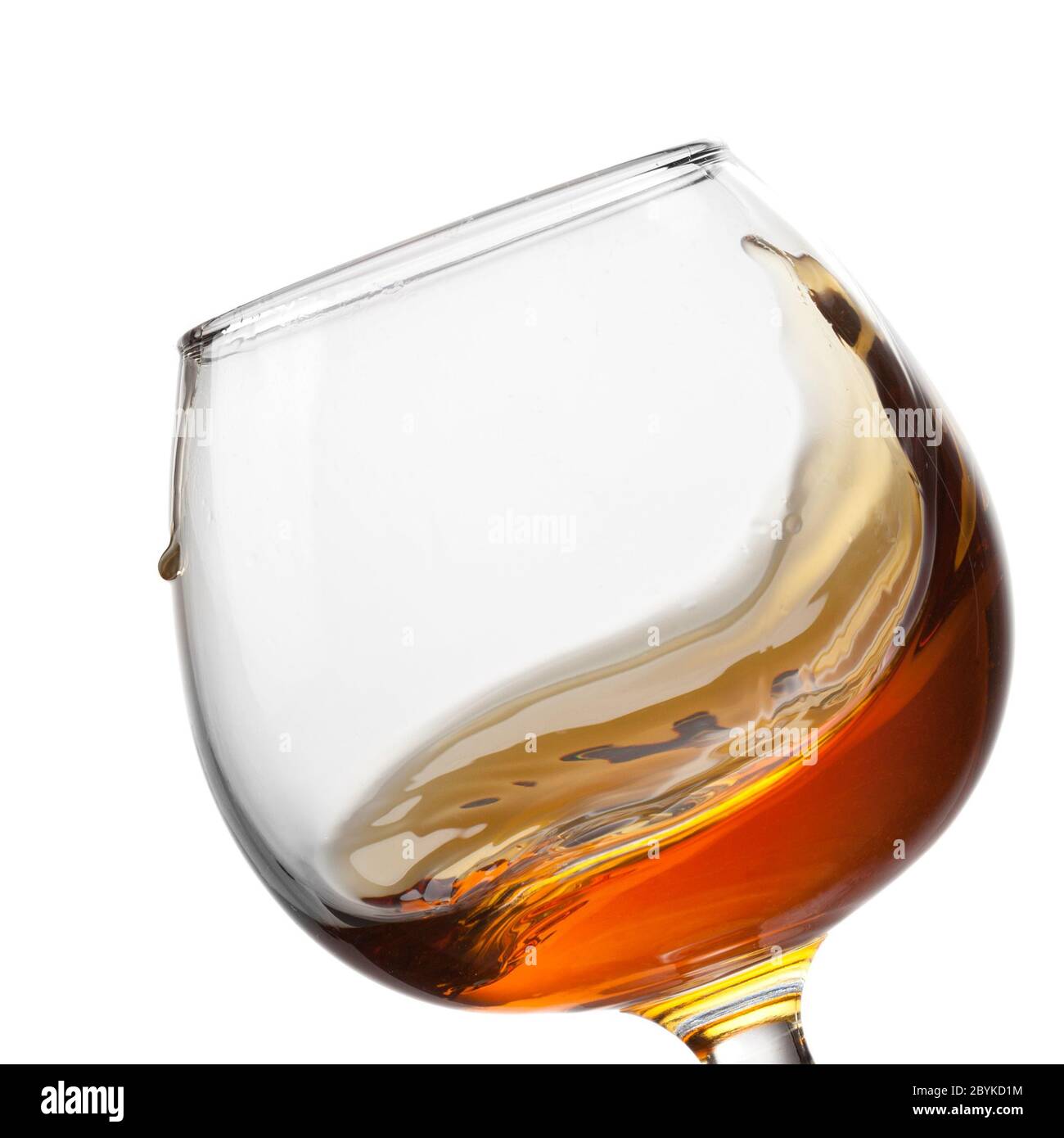 Splash of cognac in glass isolated on white background Stock Photo - Alamy