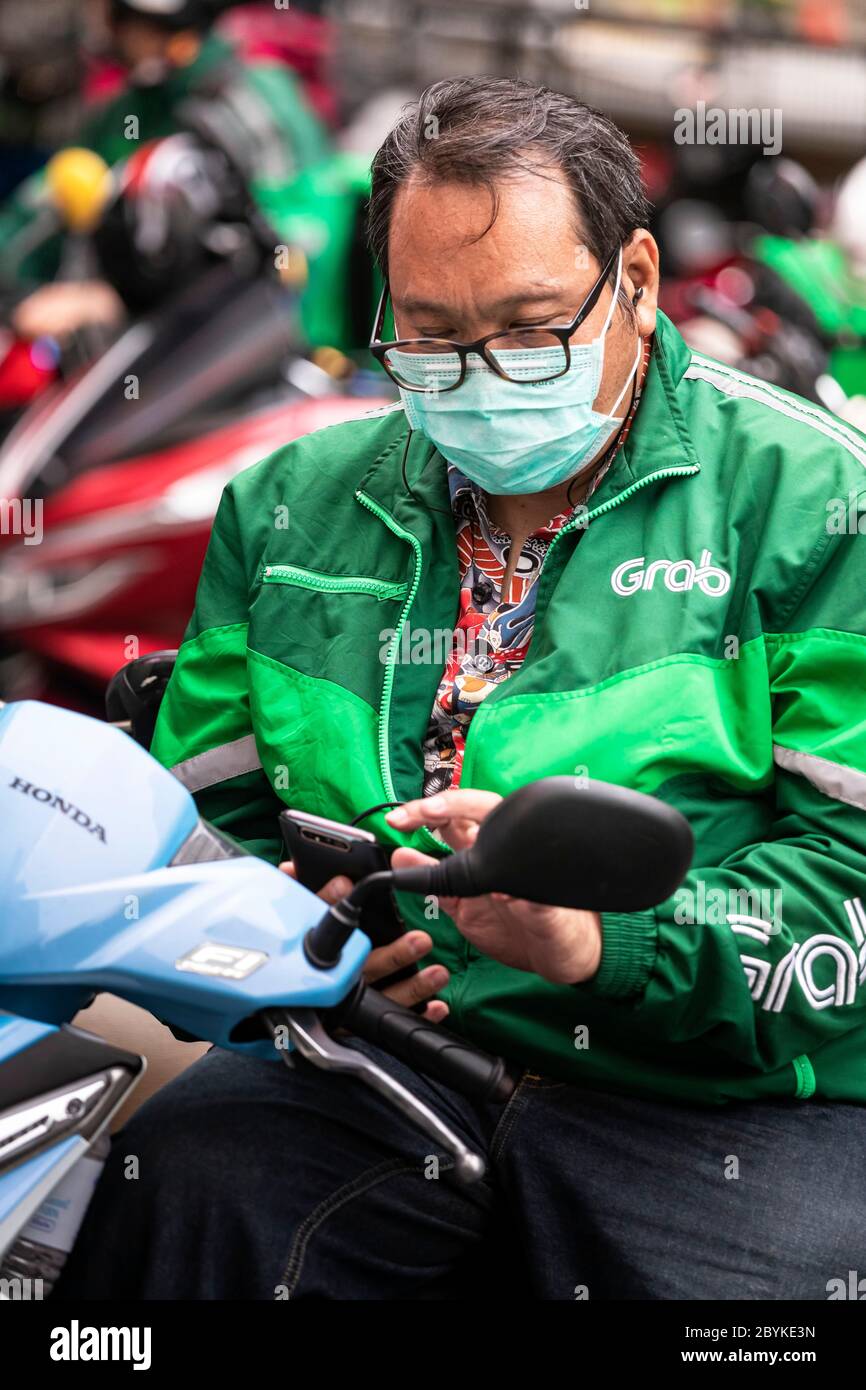 Grab motorcycle rider with face mask during Covid pandemic, Bangkok ...