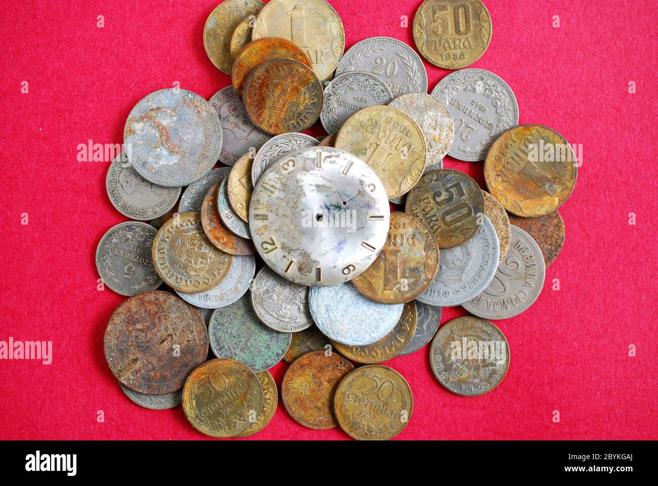 vintage clock on rusty coins on red background,image of a Stock Photo ...