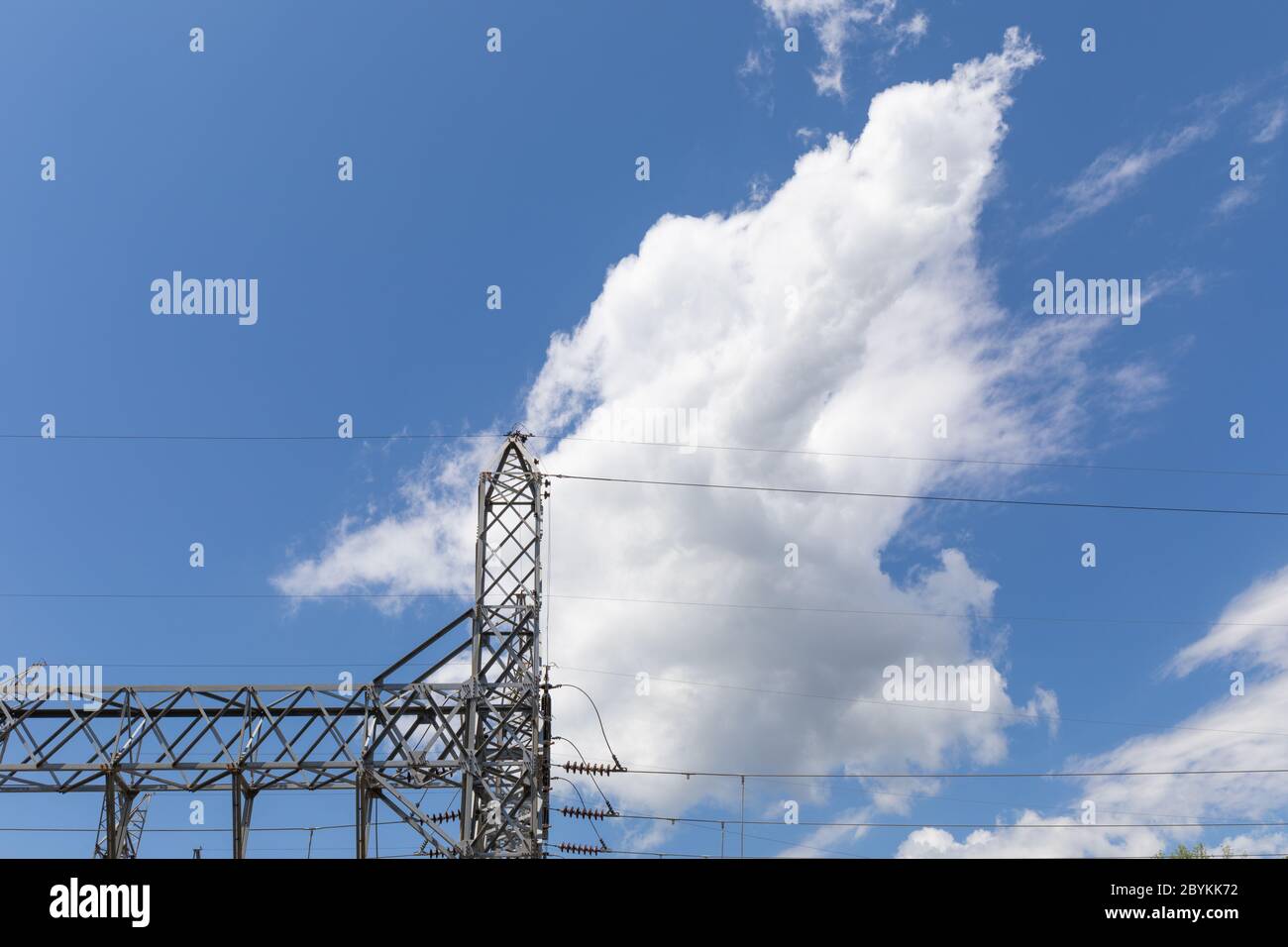 Metal trusses of an electrical power transfer station against a blue ...
