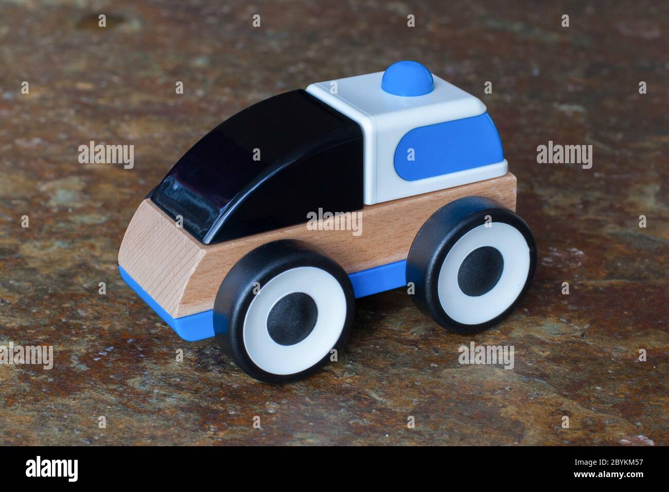 Simple wood and plastic toy police car Stock Photo - Alamy
