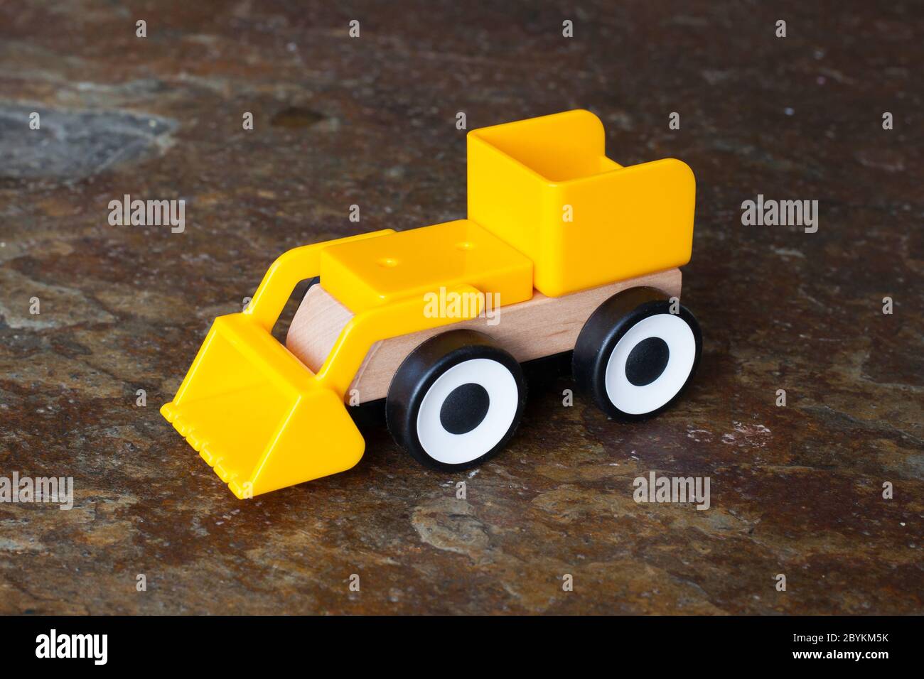 Simple wheel dozer toy Stock Photo - Alamy