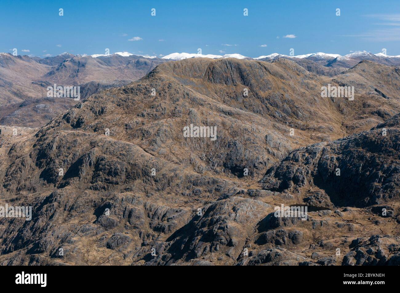 Luinne Bheinn (foreground) and the snowcapped mountains of Kintail and ...