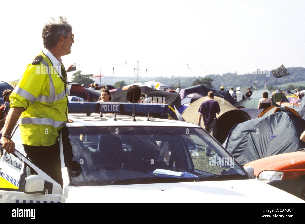 Police officer watching the campsite at the Glastonbury Festival 1999 ...