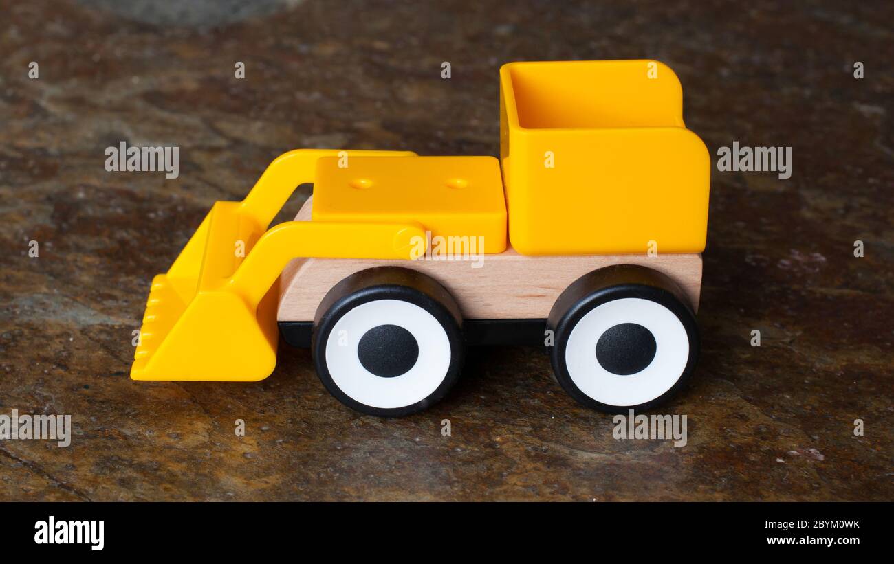Simple wheel dozer toy Stock Photo - Alamy