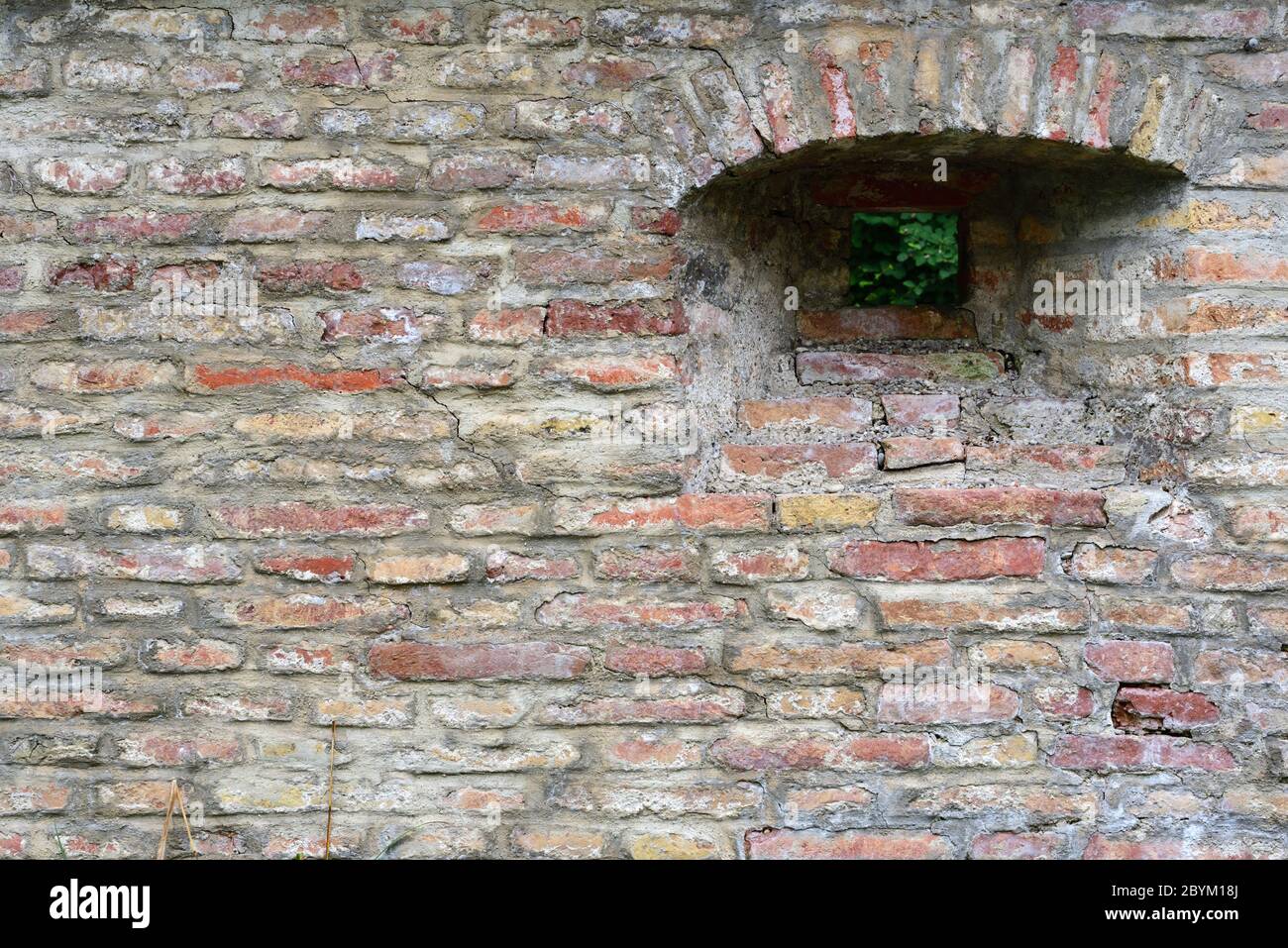 Background of a historic brick wall with a peephole on the side Stock ...
