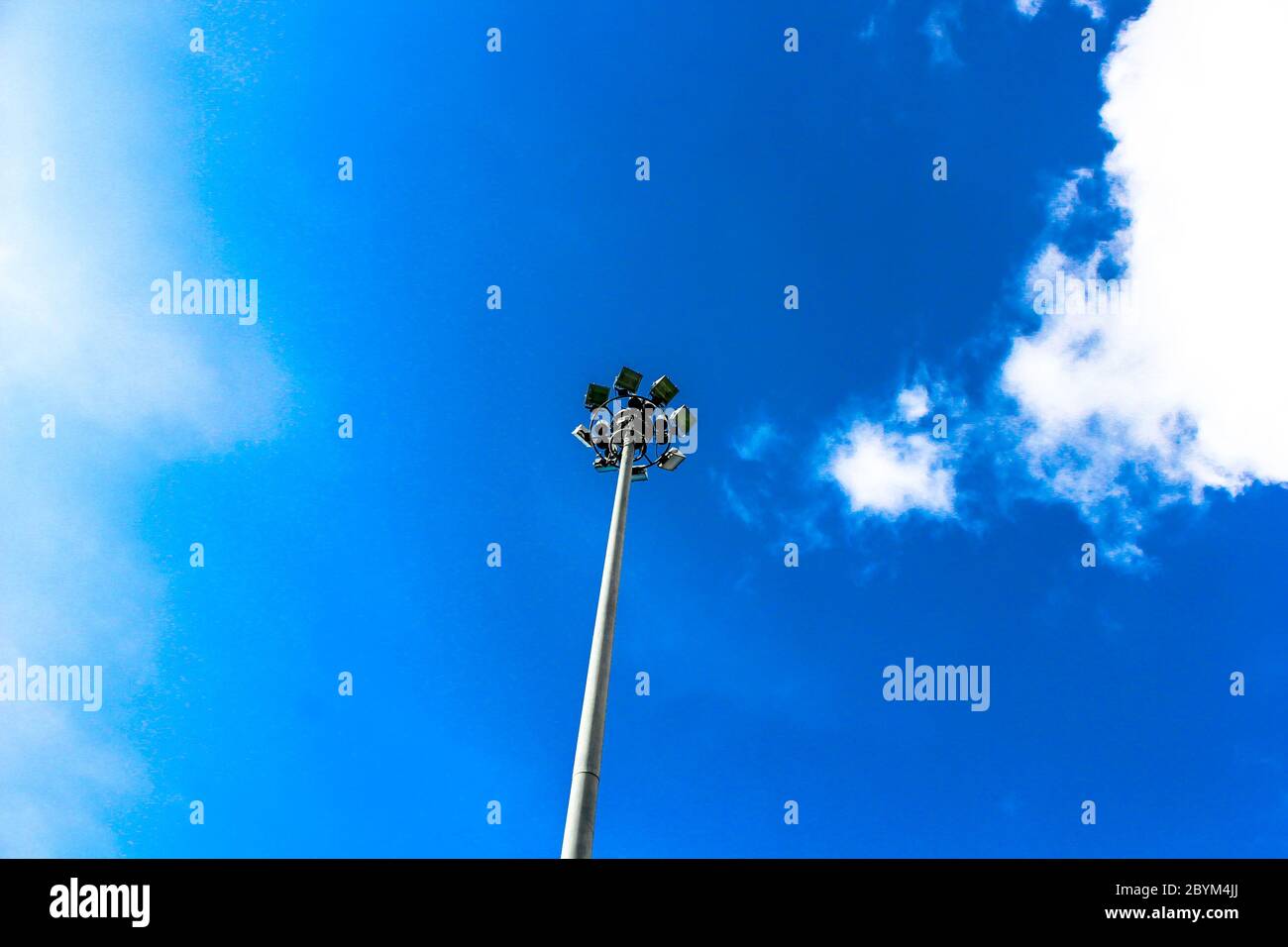 spotlight projection tower of football field isolated blue sky ...
