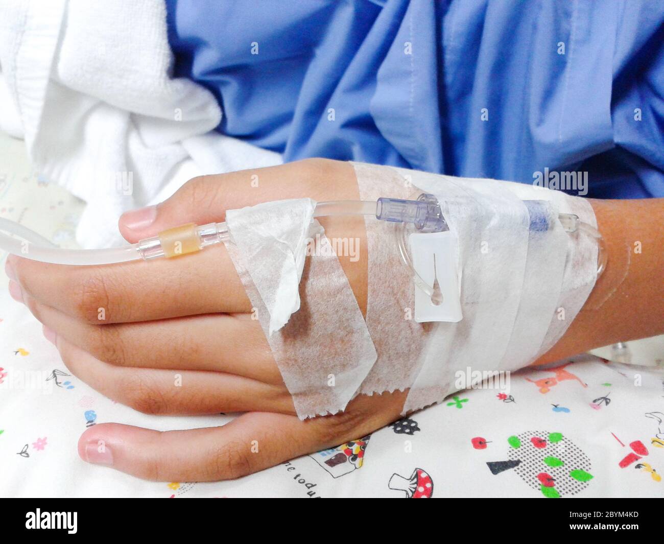 close up of hand with IV solution in a patients in hospital with saline ...