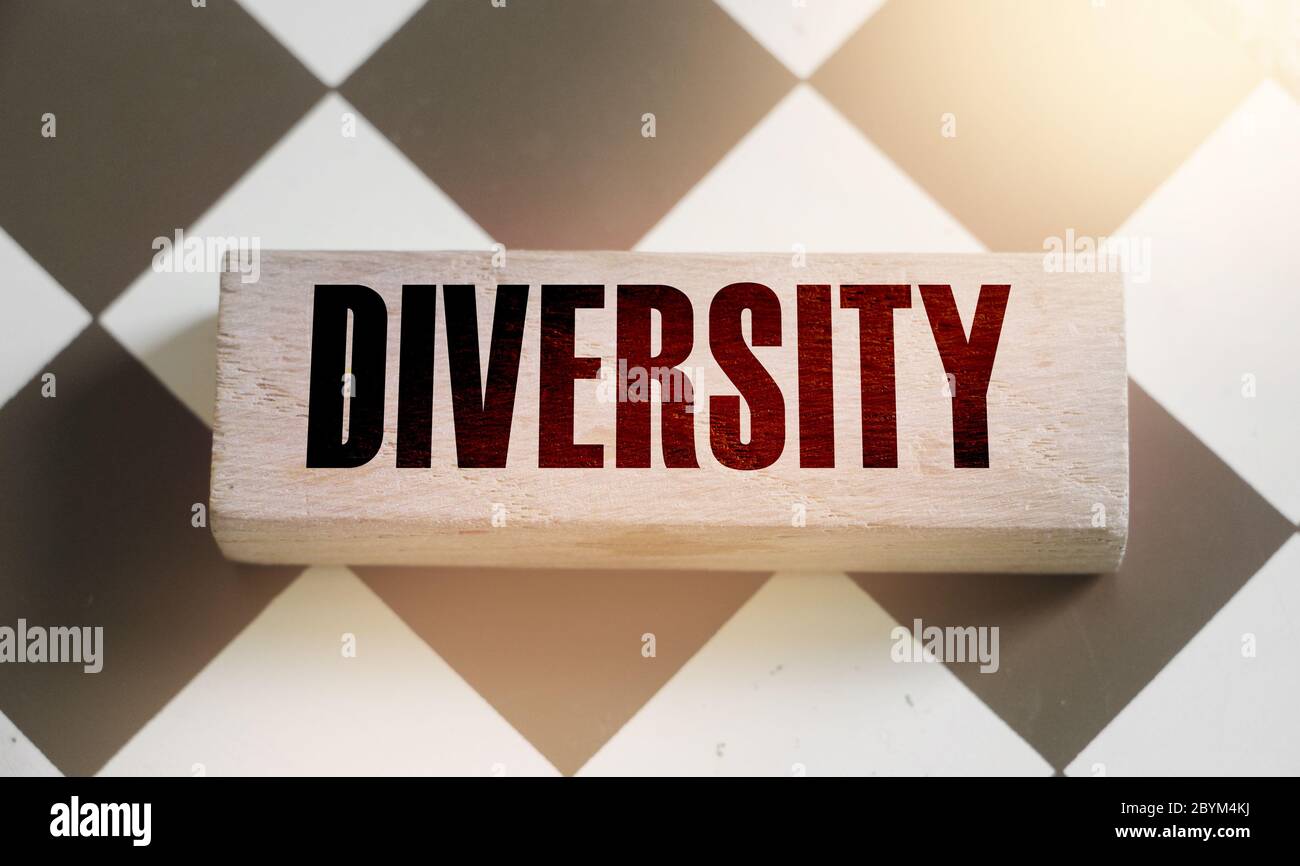 Diversity word written on wooden block on chess board. Selective focus ...