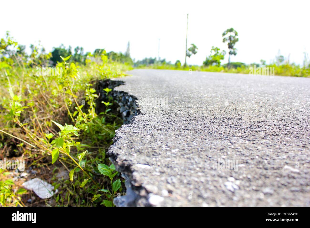 damage the asphalt road cut of soil layer with different visible ...