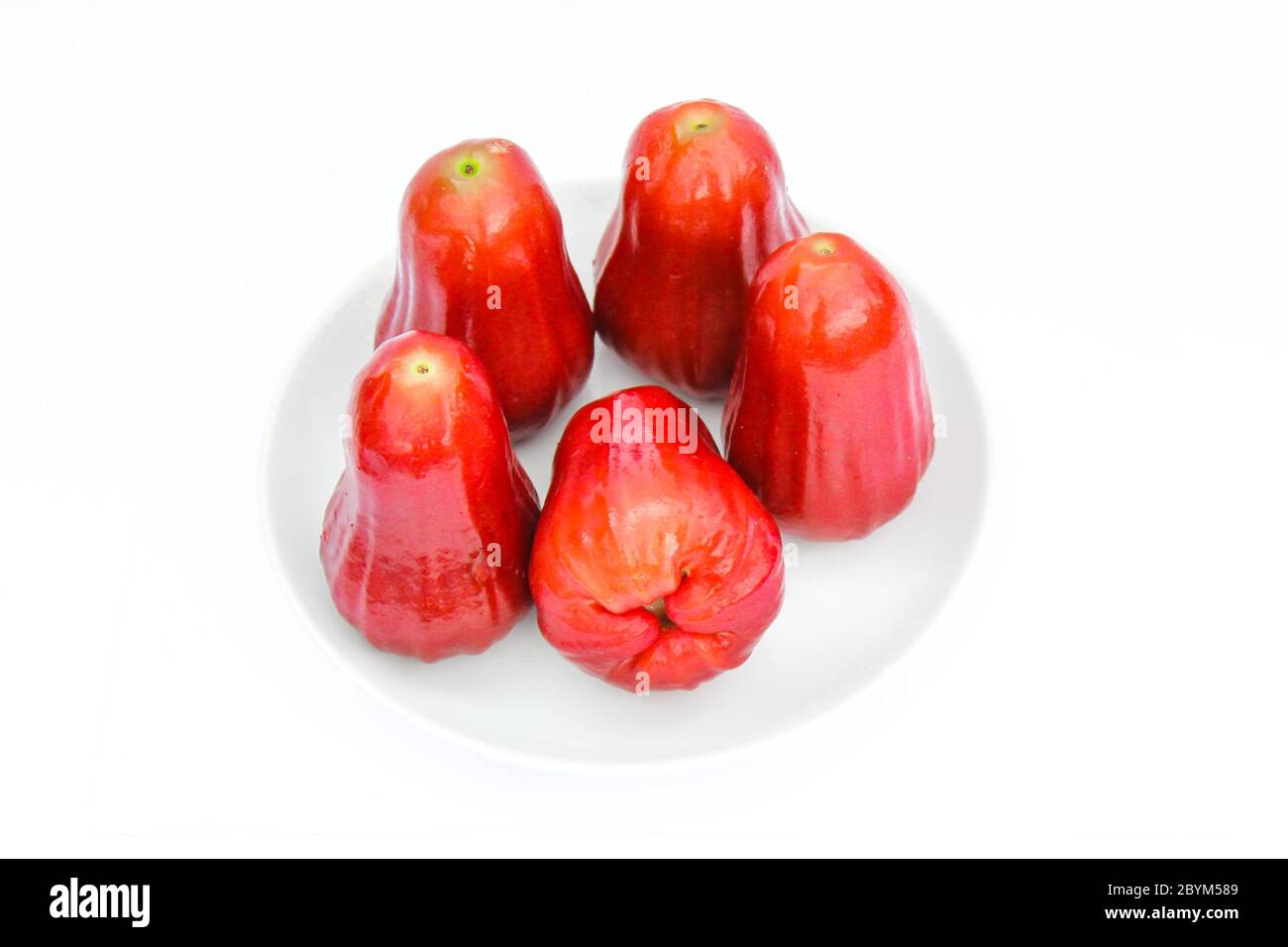 red fruit, rose apples or chompoo isolated in plate on white background ...