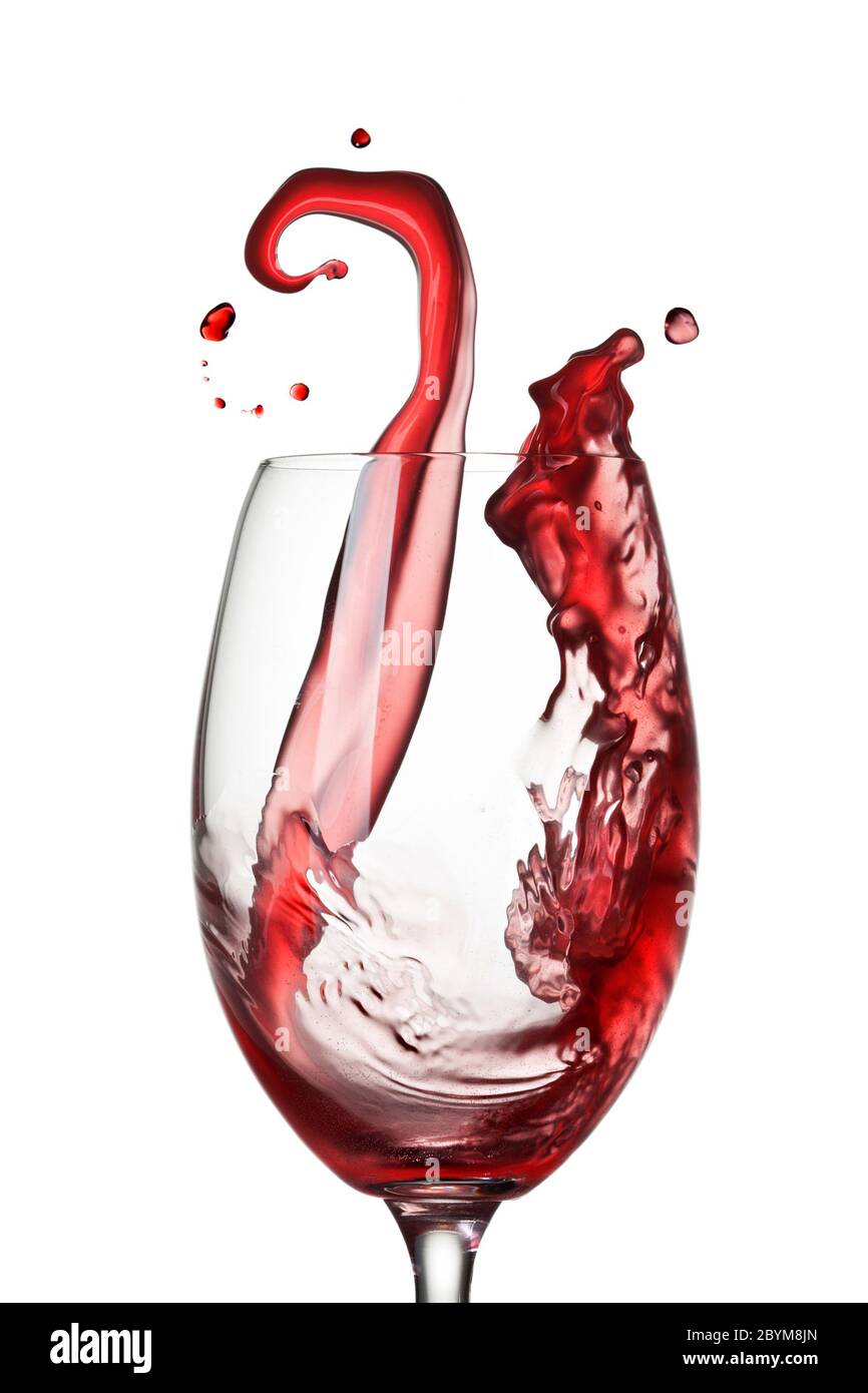 Splash of wine in glass isolated on white Stock Photo - Alamy
