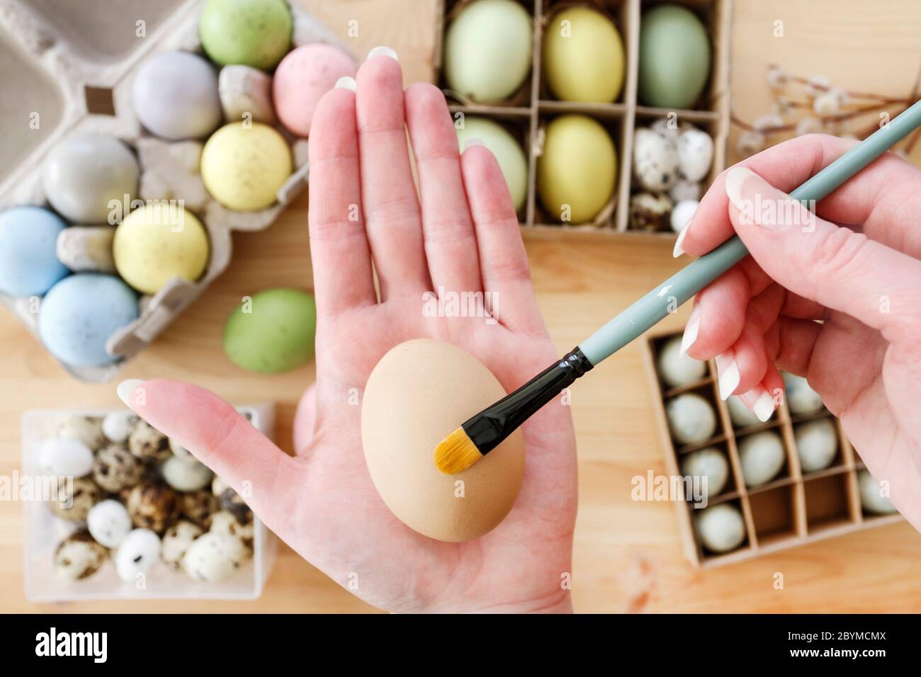 Woman holds an Easter egg in her hand. Festive time Stock Photo - Alamy