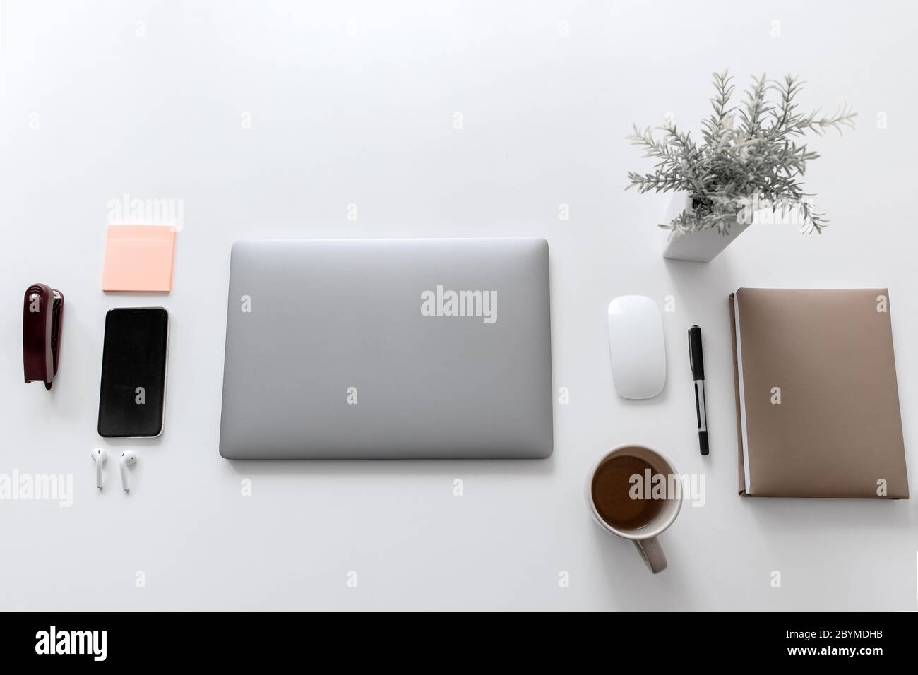 Modern white office desk table with laptop, smartphone and other ...