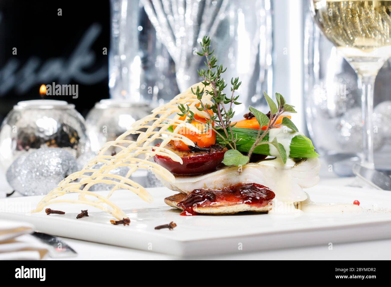 A modern dish with zander and vegetables. Table setting in luxurious ...