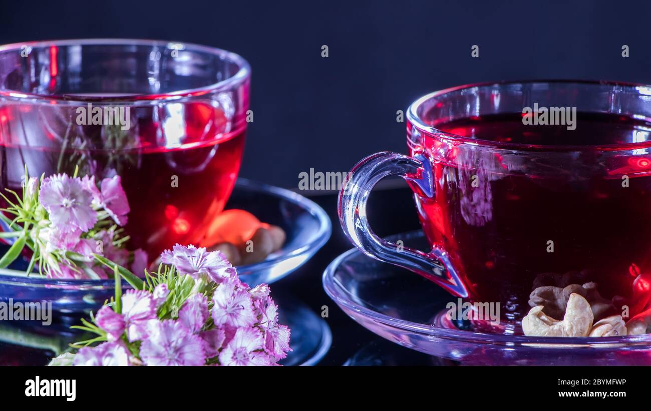Mugs of red tea with carnation flowers. Zen tea ceremony. Horizontal ...