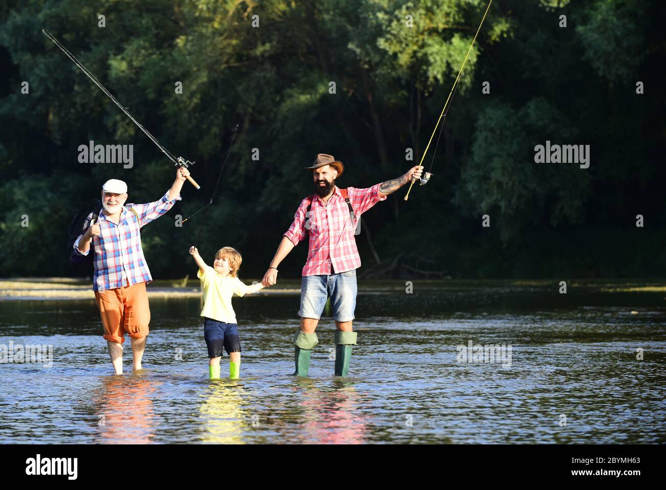Anglers. Family bonding. Boy with father and grandfather fly fishing ...